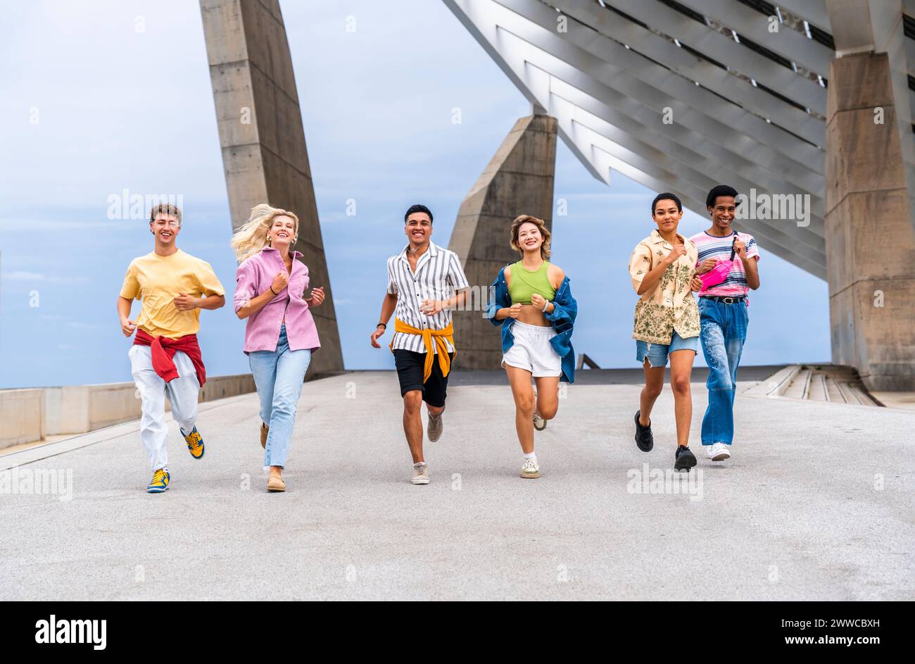 Diverse group of young friends with colorful clothing having fun ...