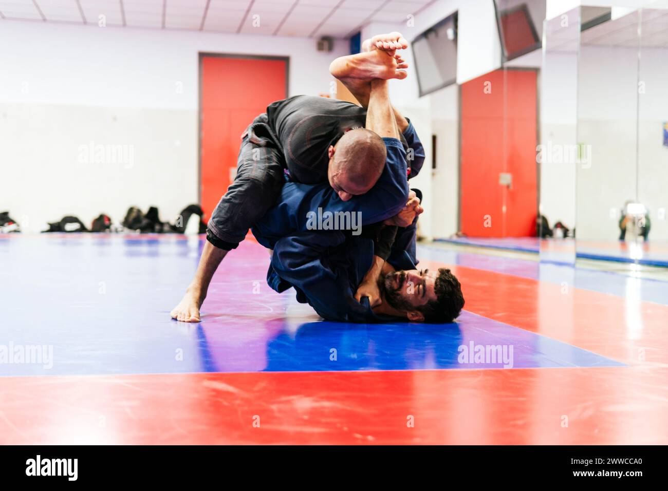 Athletes practicing jiu-jitsu at dojo Stock Photo - Alamy