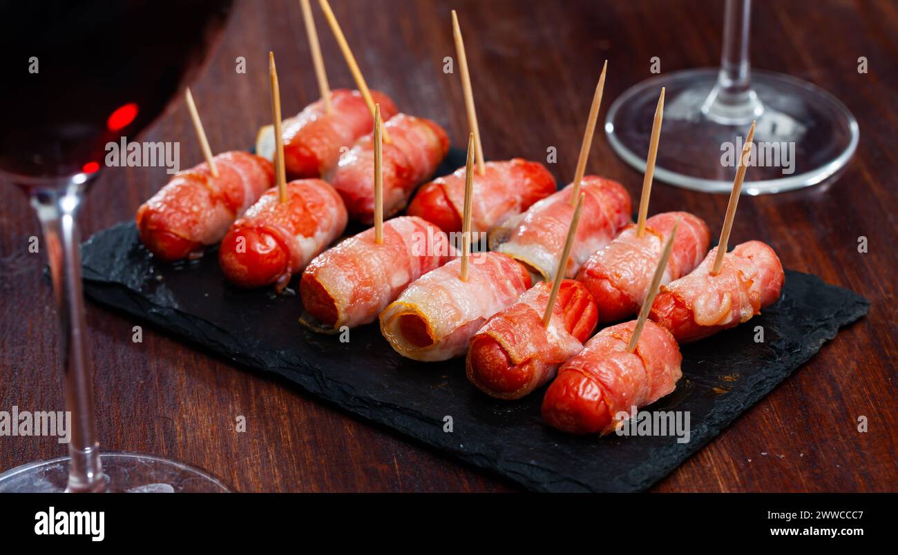 Spanish tasty meal rolled in bacon sausages at plate Stock Photo - Alamy
