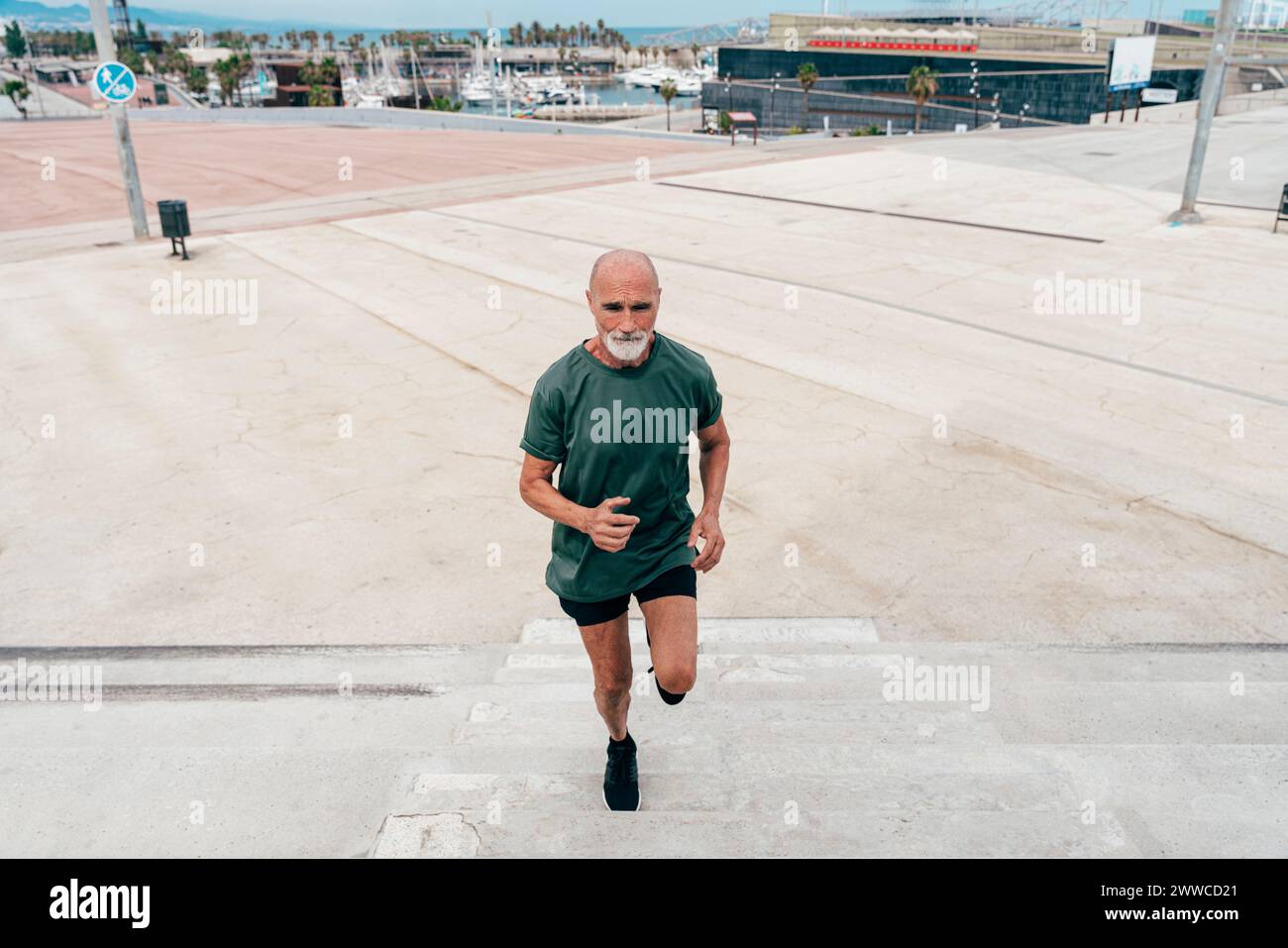 Fit retired senior man moving up on staircase Stock Photo - Alamy