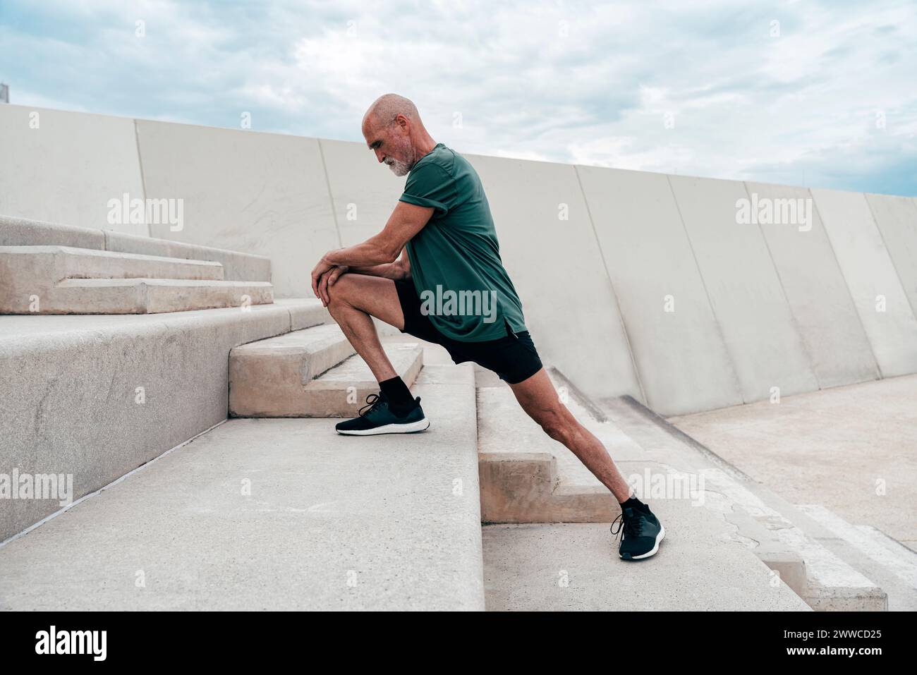 Active senior man stretching on steps Stock Photo - Alamy