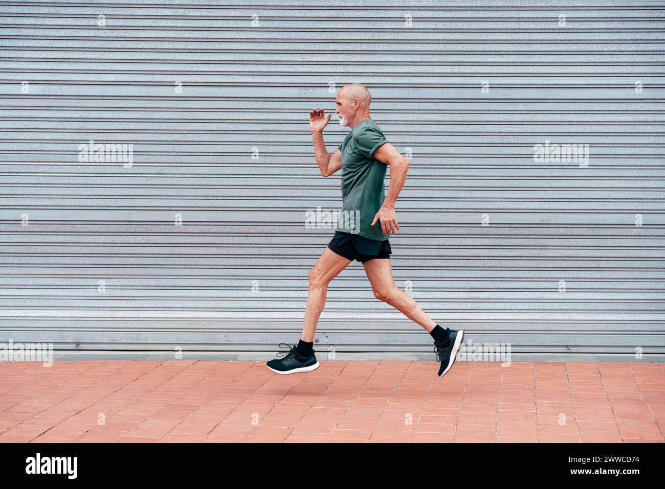 Determined active senior man running by shutter Stock Photo - Alamy