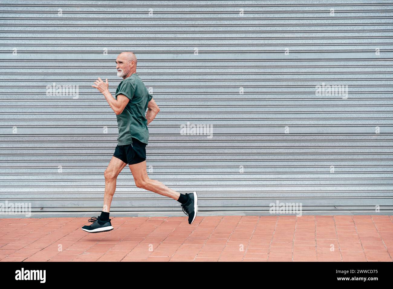 Determined active senior man running by shutter Stock Photo - Alamy