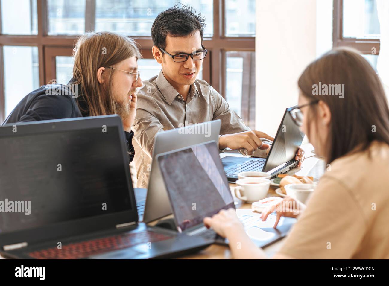 Business team collaborating over laptops hi-res stock photography and ...