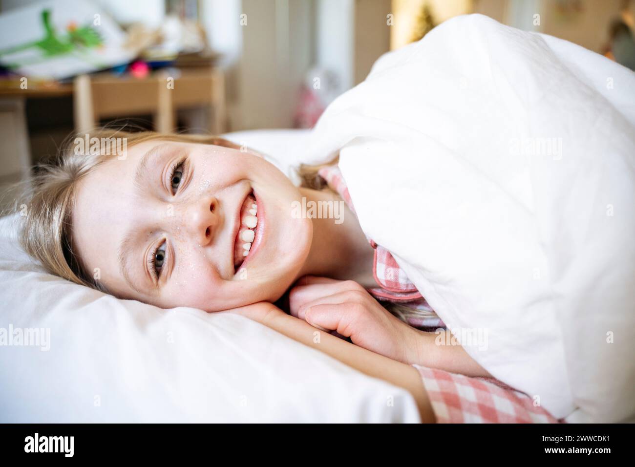 Blonde girl lying in bed hi-res stock photography and images - Alamy