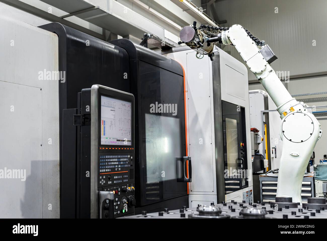 Robotic arm with machinery in factory Stock Photo - Alamy