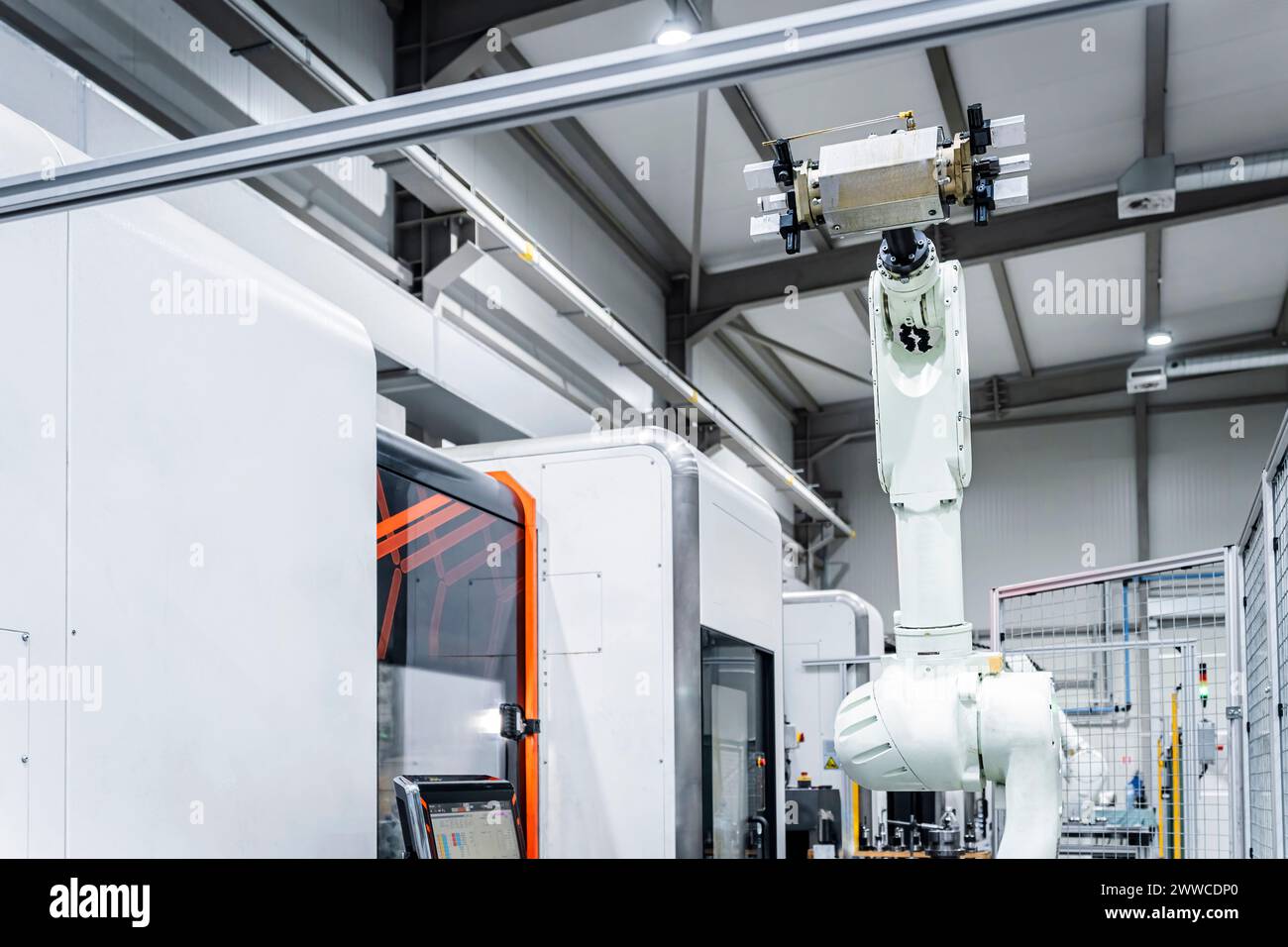White robotic arm in modern manufacturing building Stock Photo - Alamy