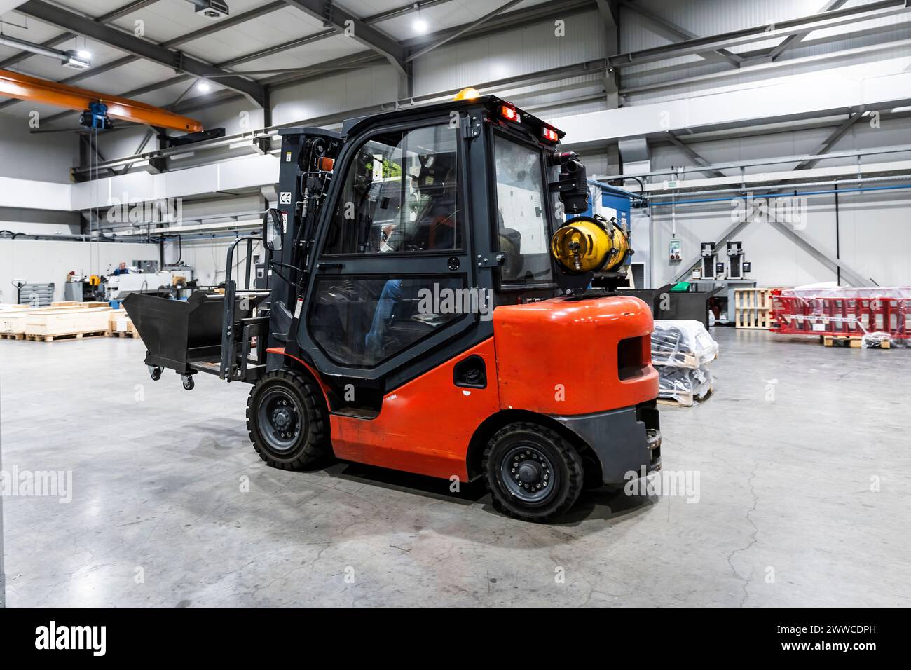 Red forklift in illuminated modern factory Stock Photo - Alamy