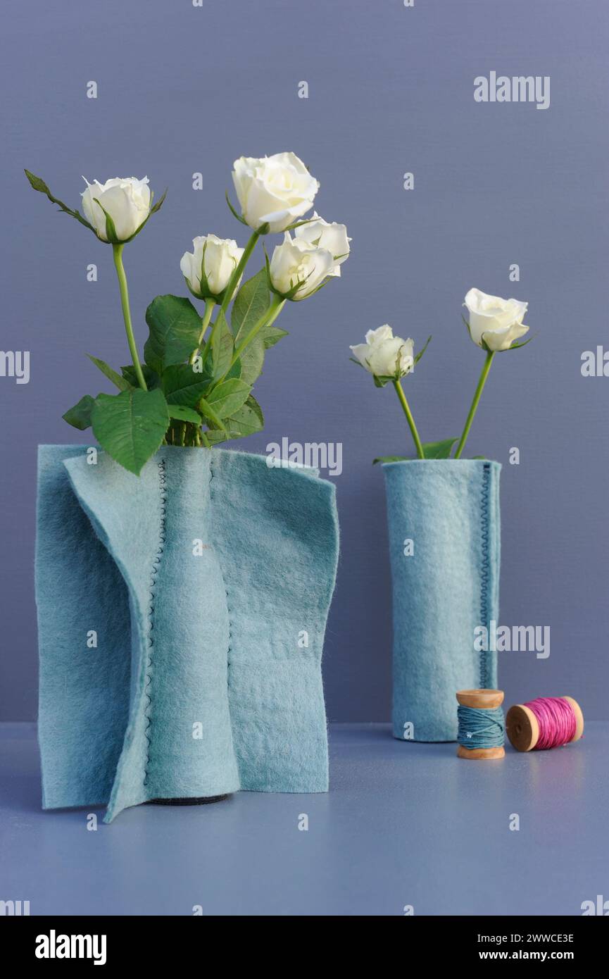 White roses in felt covered vases Stock Photo - Alamy