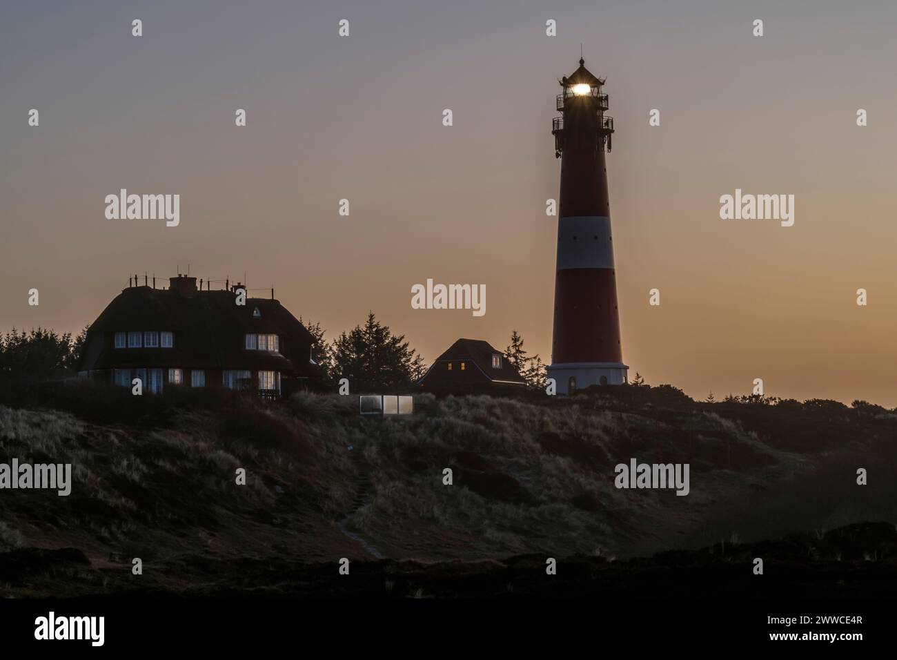 Germany, Schleswig-Holstein, Hornum, Lighthouse on Sylt island at dawn ...