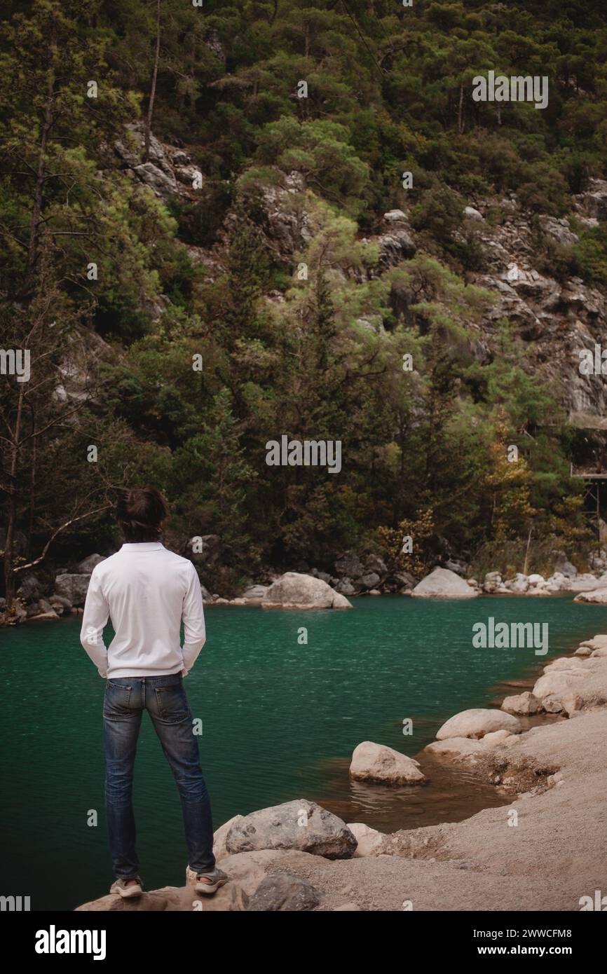 Man on the background of a mountain lake, tranquility and unity with ...