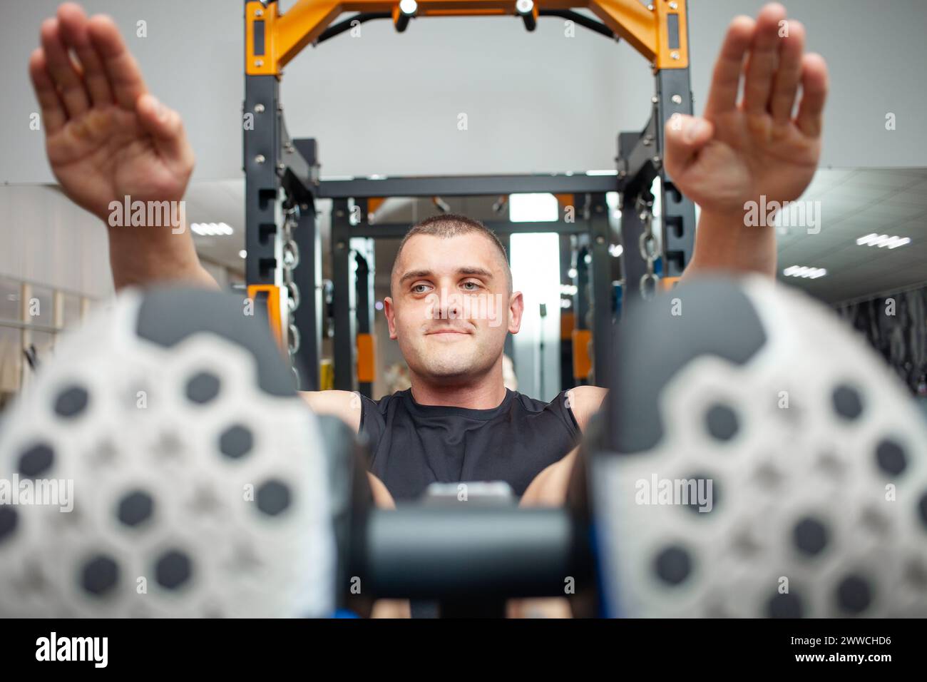 The trainer perform an exercise on the simulator in the gym, happy ...