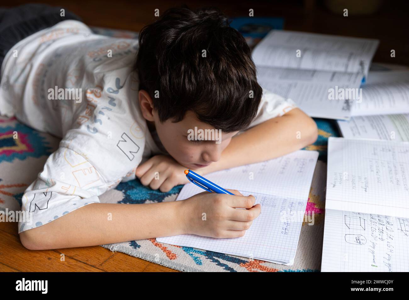 Elementary school student doing assignment hi-res stock photography and ...