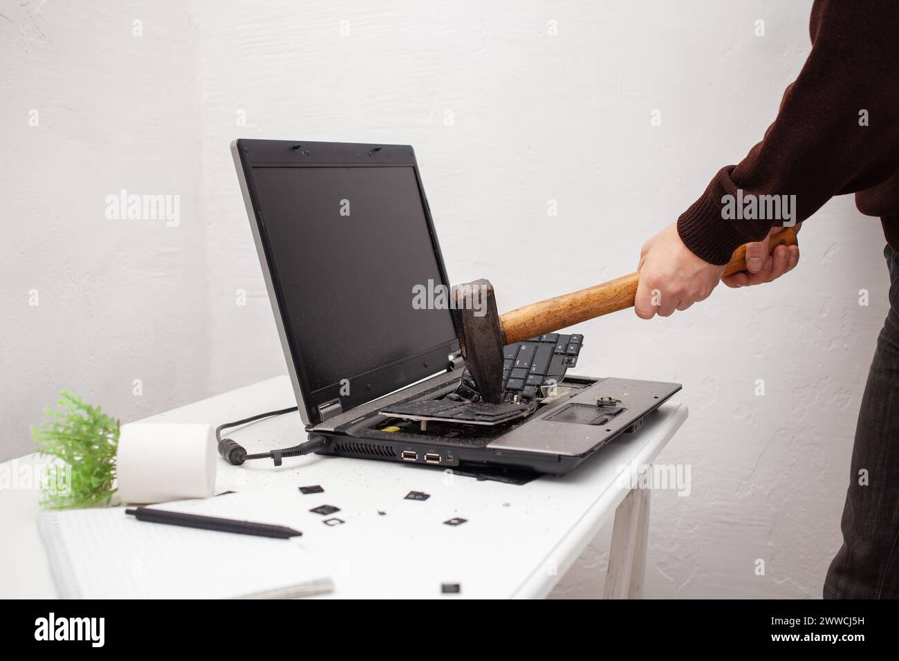 A man office worker smashed a laptop, destroyed a computer. Anger ...