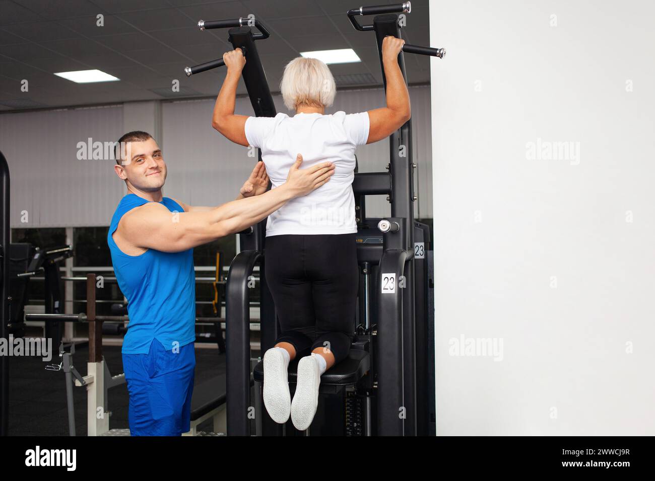 Reabelitation after injury. An elderly woman plays sports in the gym ...