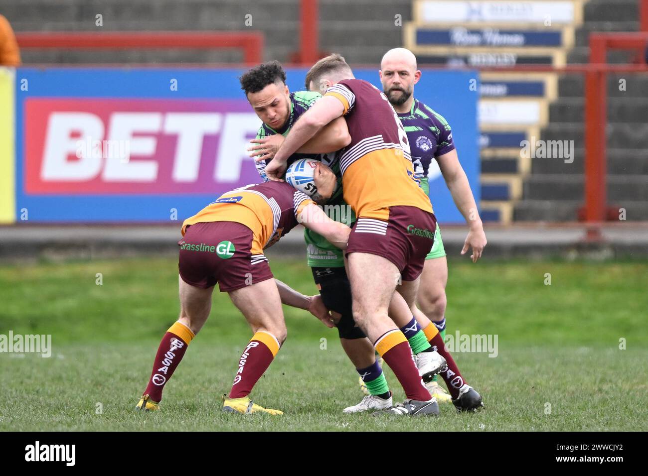 Liam Horne of Castleford Tigers is tackled Adam Gledhill of Batley ...