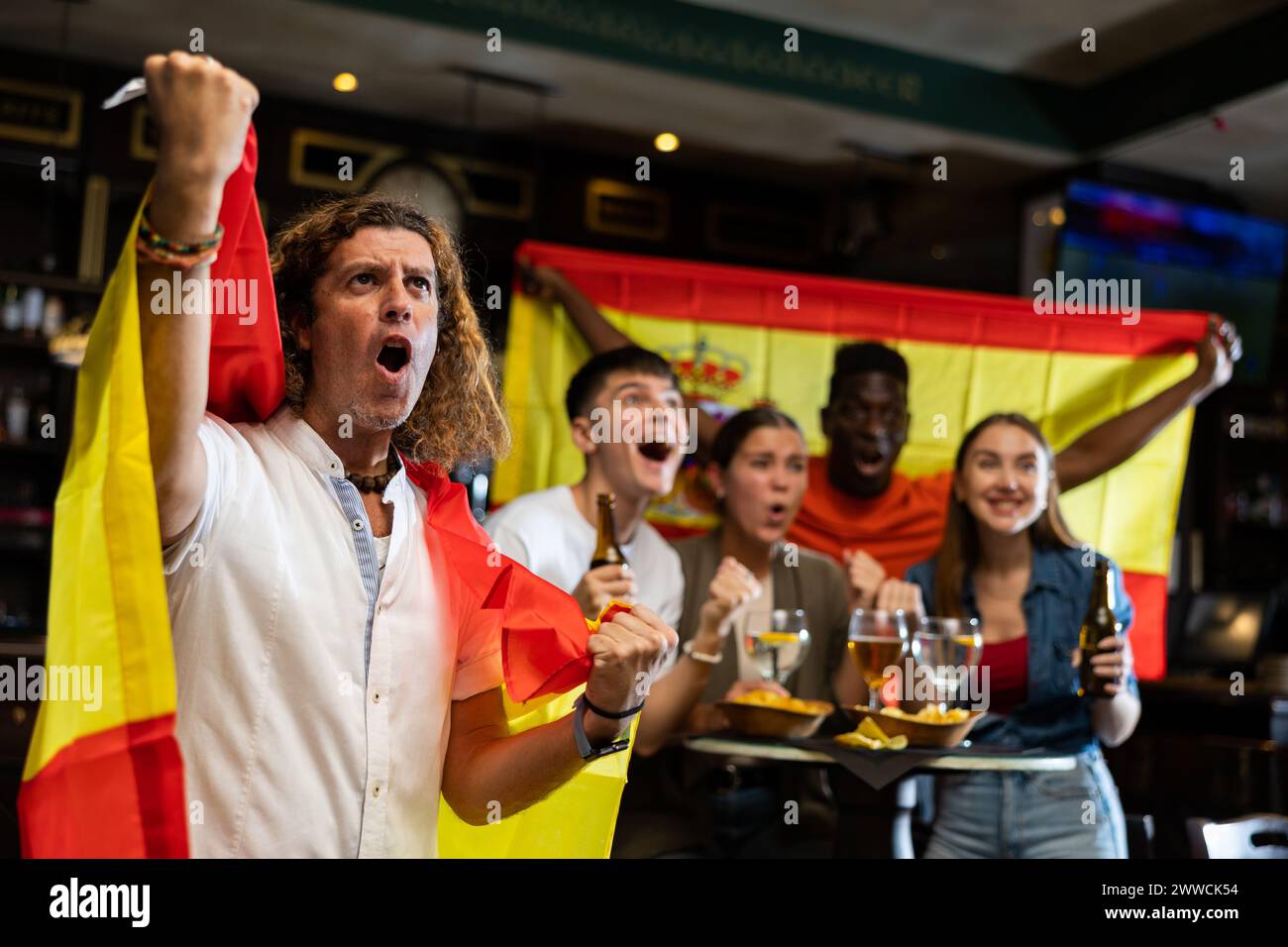 Excited man with national Spanish flag rooting for favorite team in ...