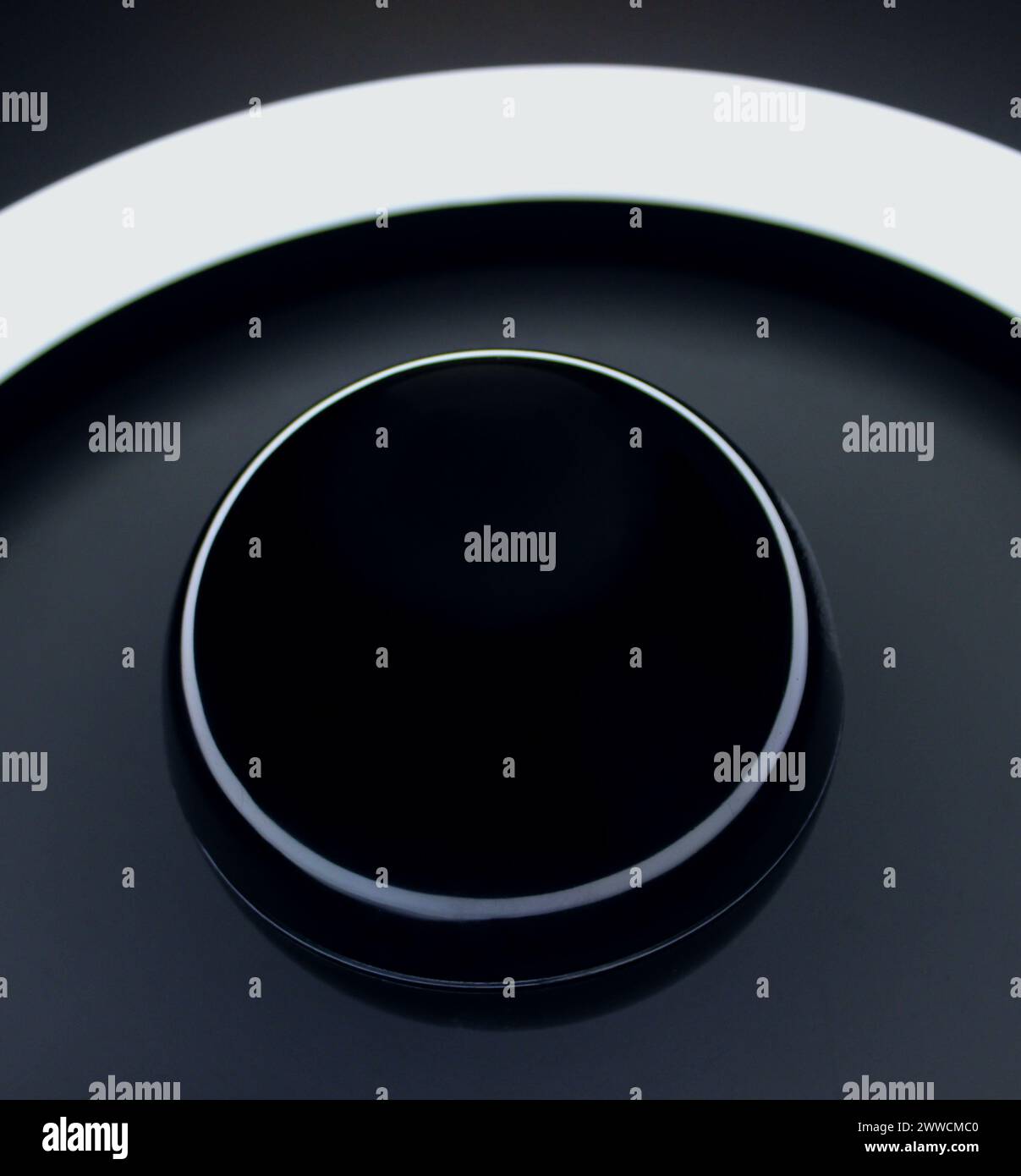 A black sphere that looks like a planet with rings of light around it ...