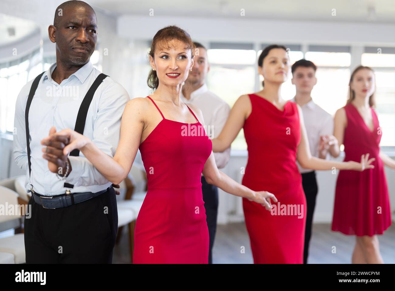 Group lesson - waltz training, male and female participants stand in ...