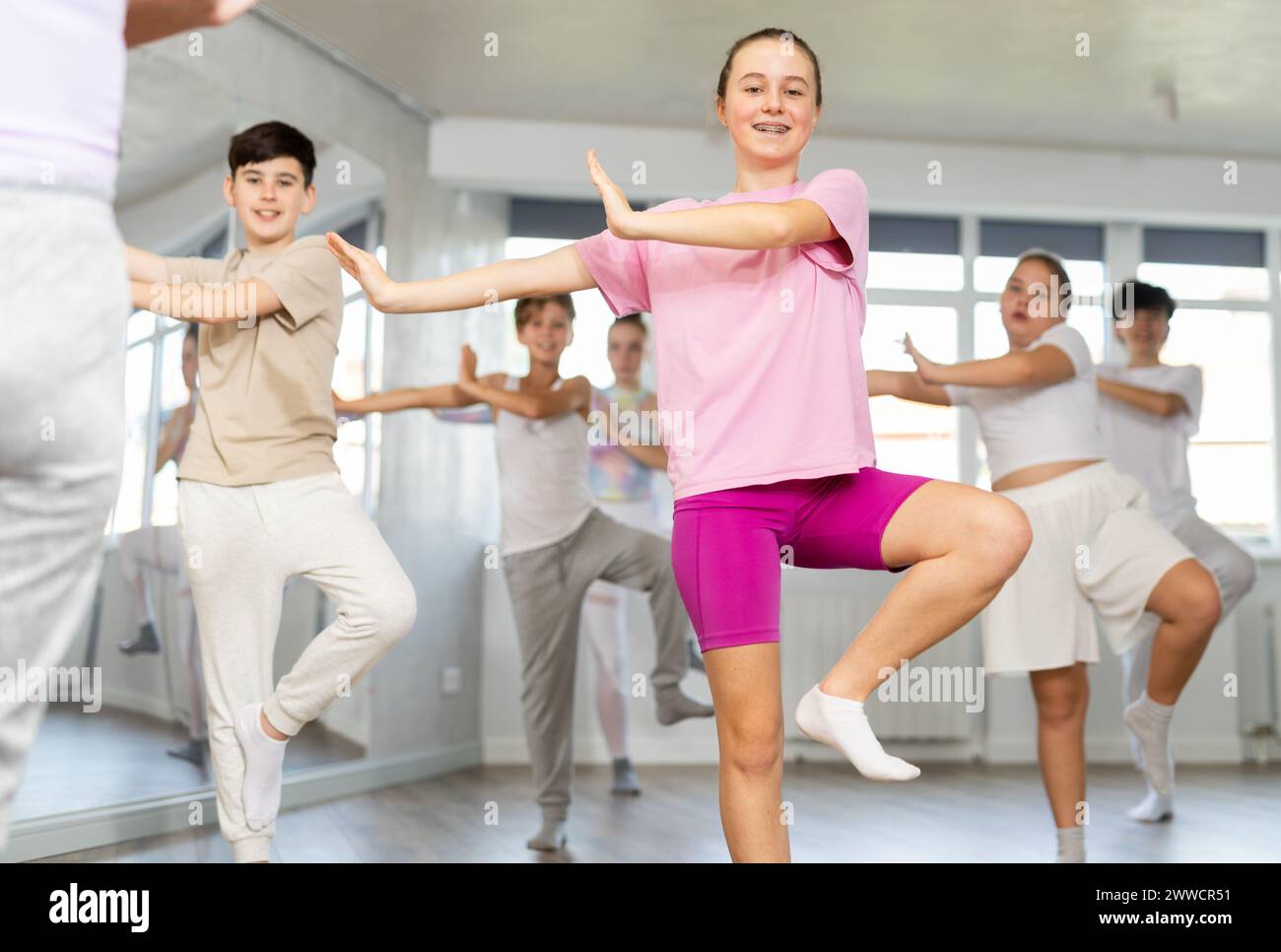Female girl student repeats movements of unrecognizable teacher during ...