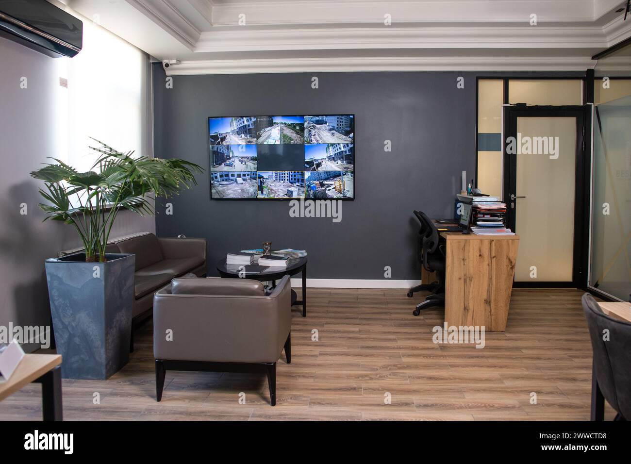A stylish and modern office interior with dark gray walls, a large ...