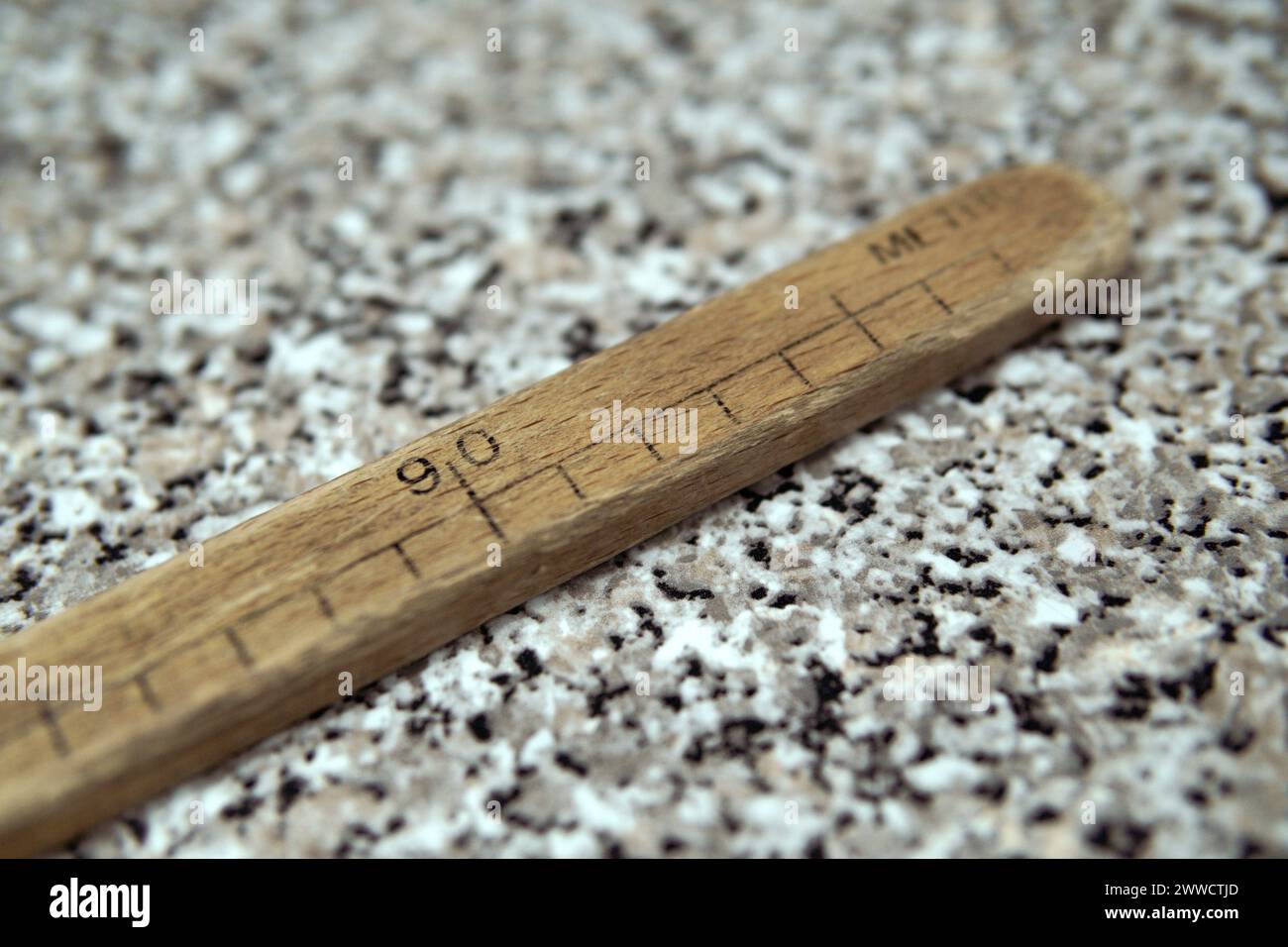 wood ruler on the brown wooden background Stock Photo - Alamy