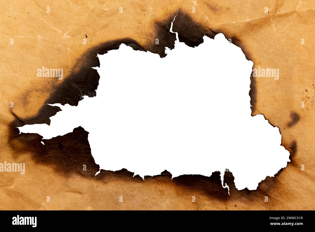 Burnt hole in yellow paper. Burnt paper Stock Photo - Alamy