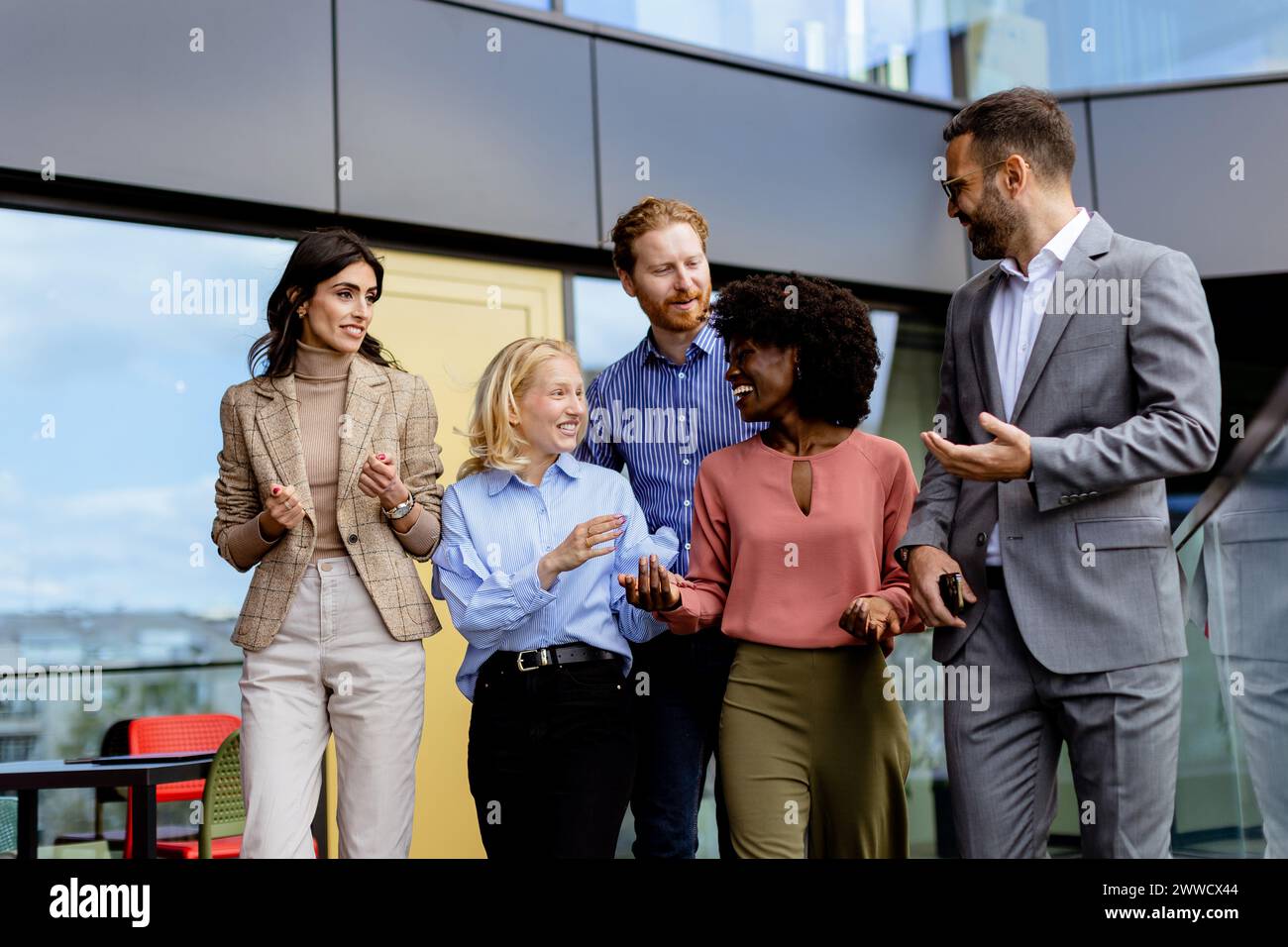 A group of businness people colleagues gathers for a casual ...