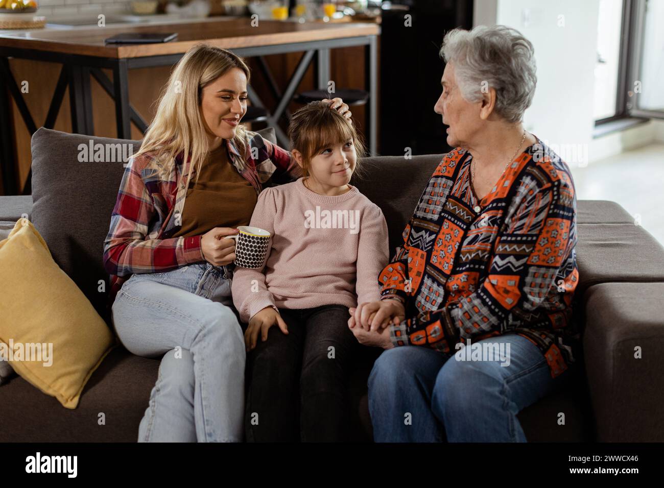 Three generations of women enjoy laughter and conversation on a ...