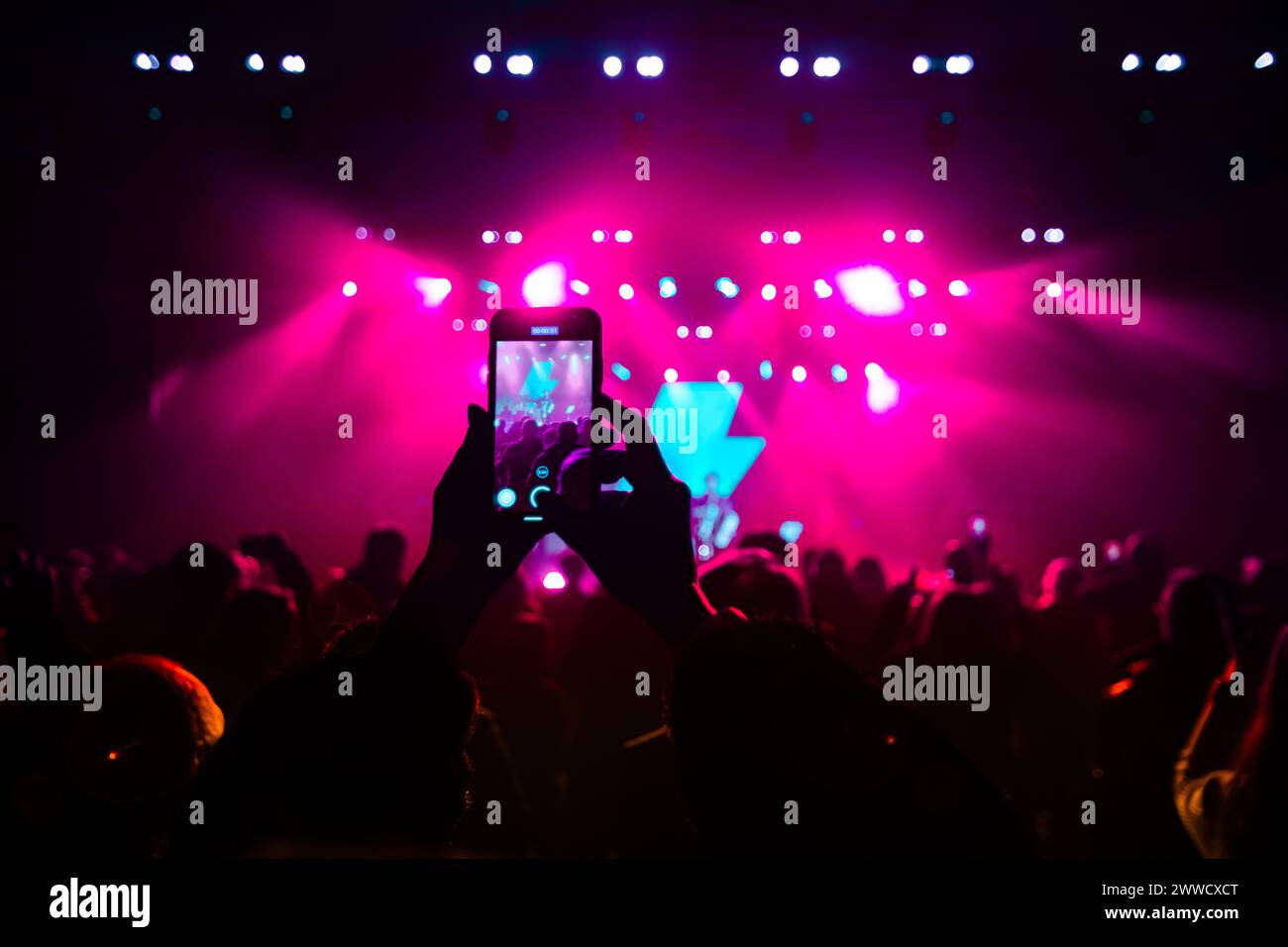 Hands with phones on concert, atmosphere on concert, stage lights Stock ...