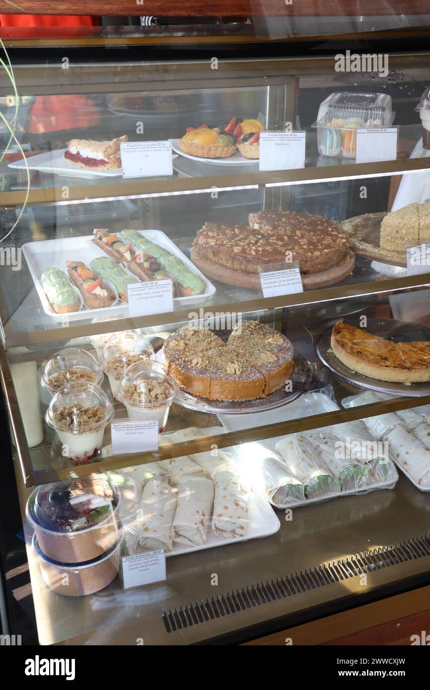 Food display case showcasing a variety of baked goods and desserts ...