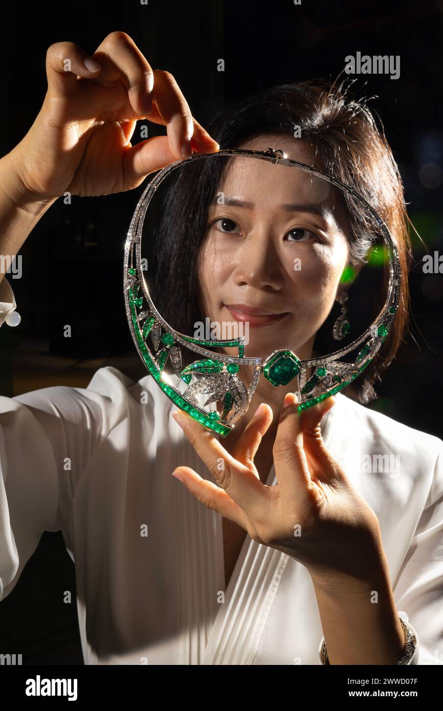 22/03/24 Charlene Li, 40, inspects the emerald and diamond centrepiece ...