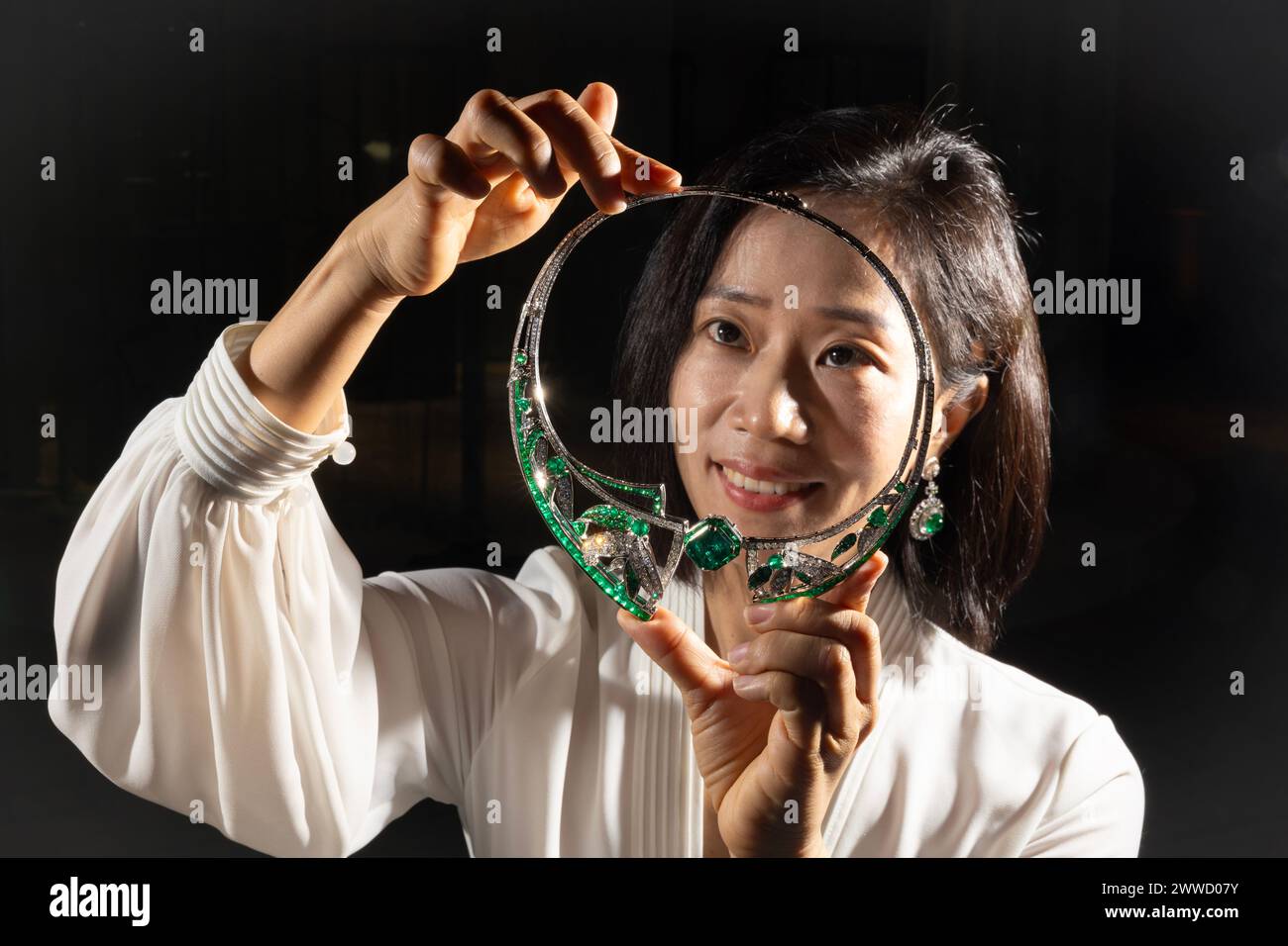 22/03/24 Charlene Li, 40, inspects the emerald and diamond centrepiece also known as Zhu Ying ...
