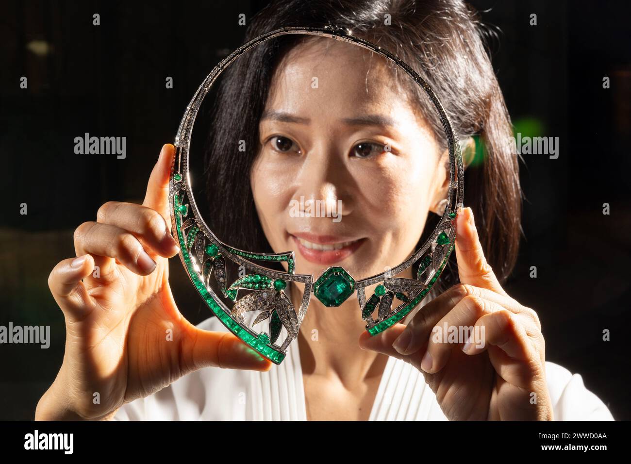 22/03/24 Charlene Li, 40, inspects the emerald and diamond centrepiece ...