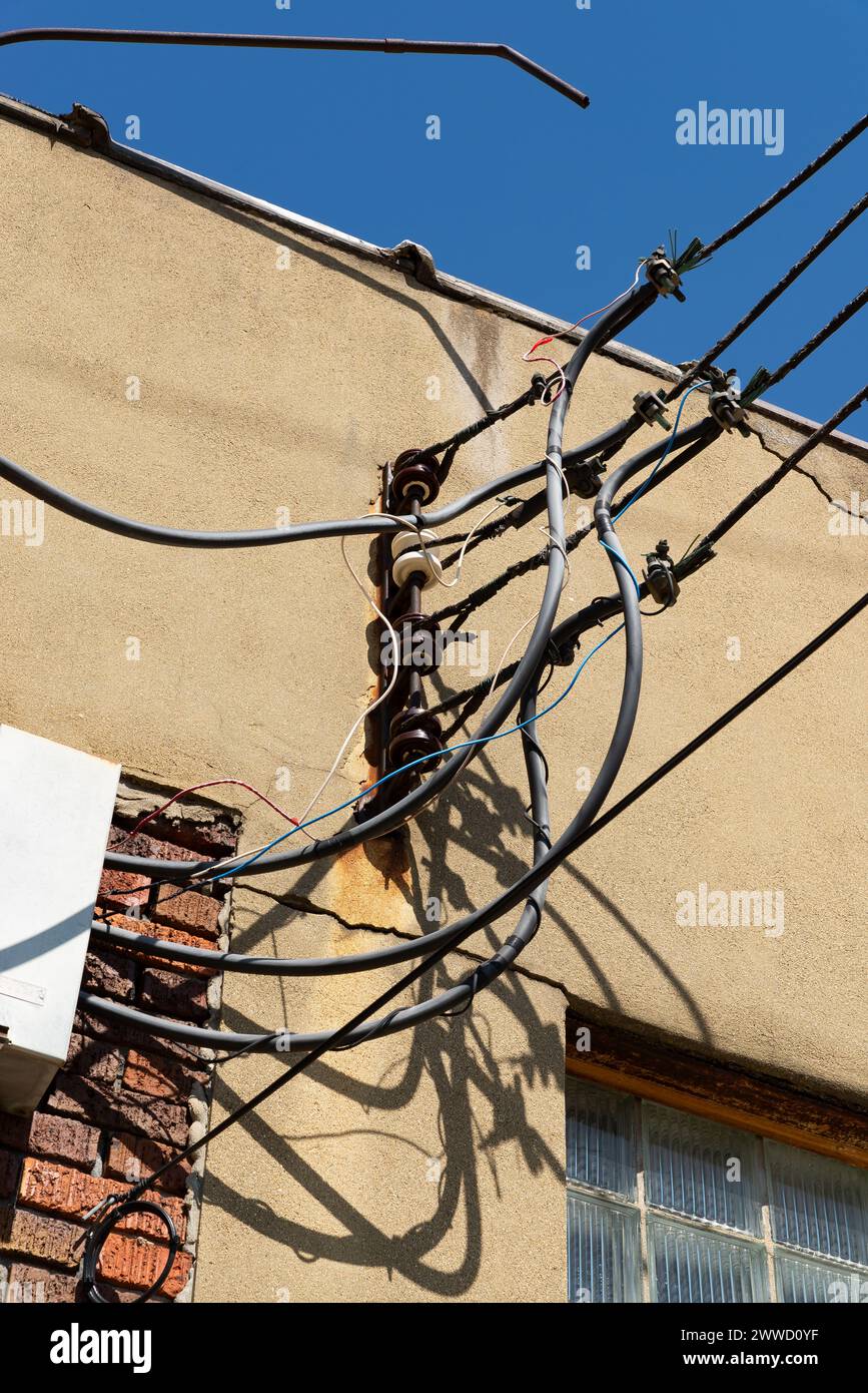 Electrical wires connected to warehouse building in Midwest city Stock ...