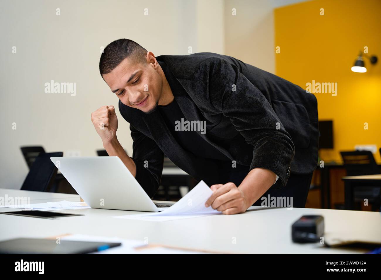 Young man bending over table hi-res stock photography and images - Alamy