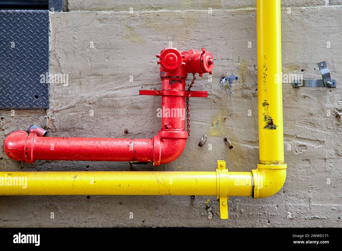 Horizontal View of Red and Yellow Pipes Strapped to a Exterior Wall ...