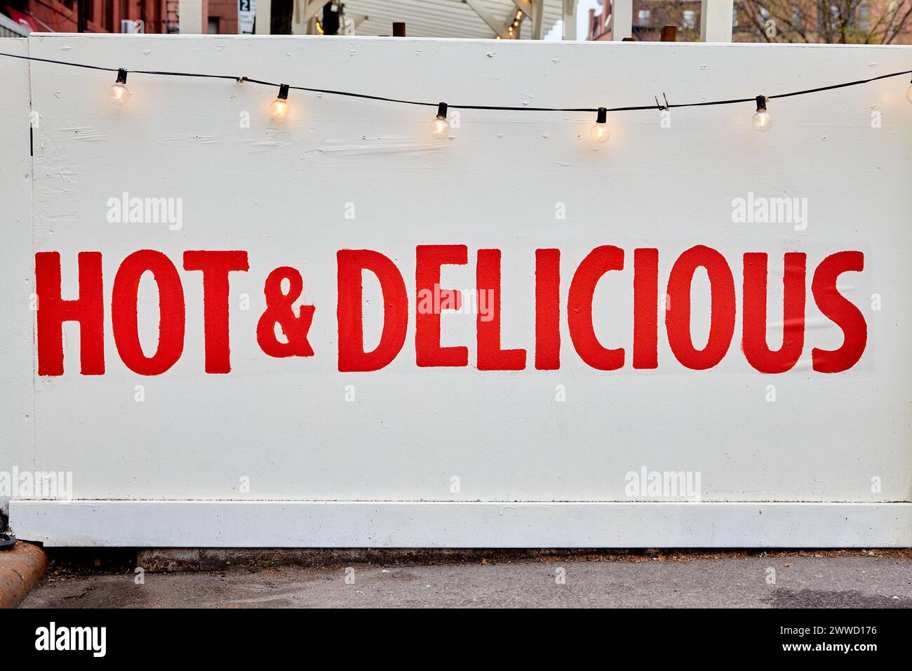 Hot and Delicious Sign with String of Lights Stock Photo - Alamy