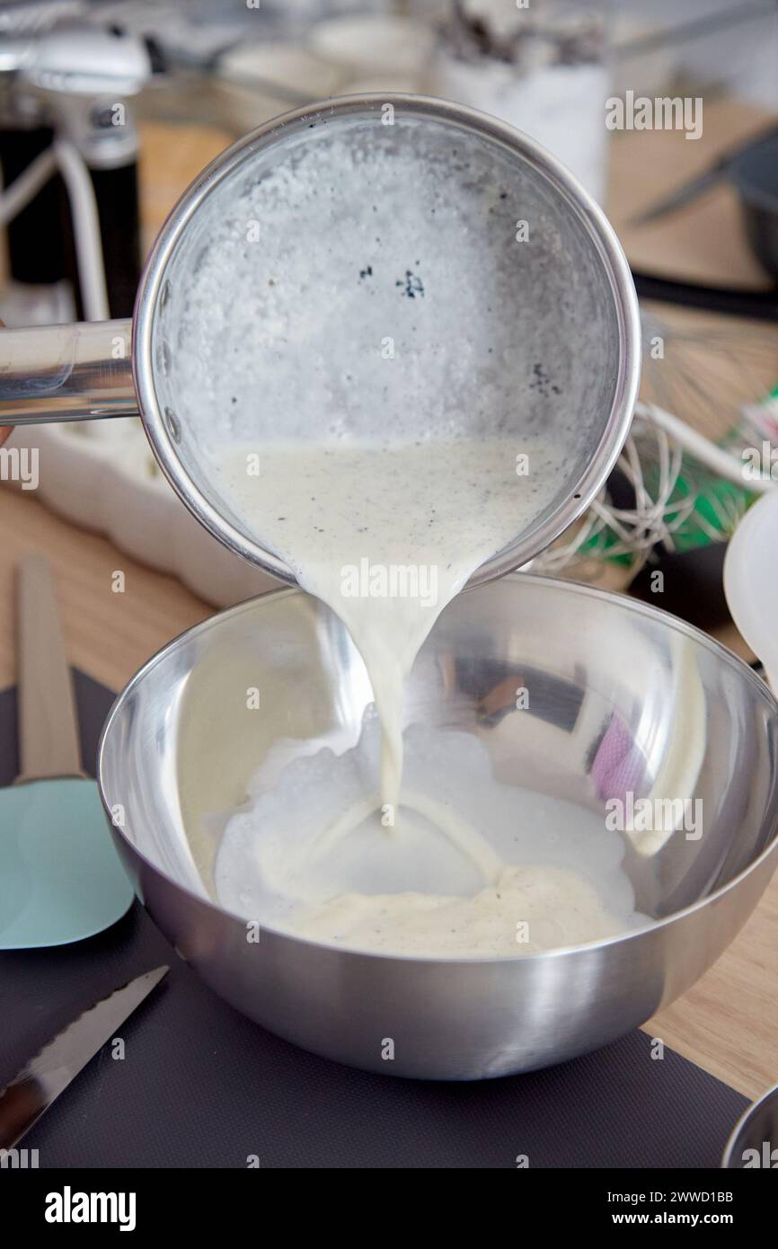 Pouring Cream Mixture with Vanilla into Bowl Stock Photo - Alamy