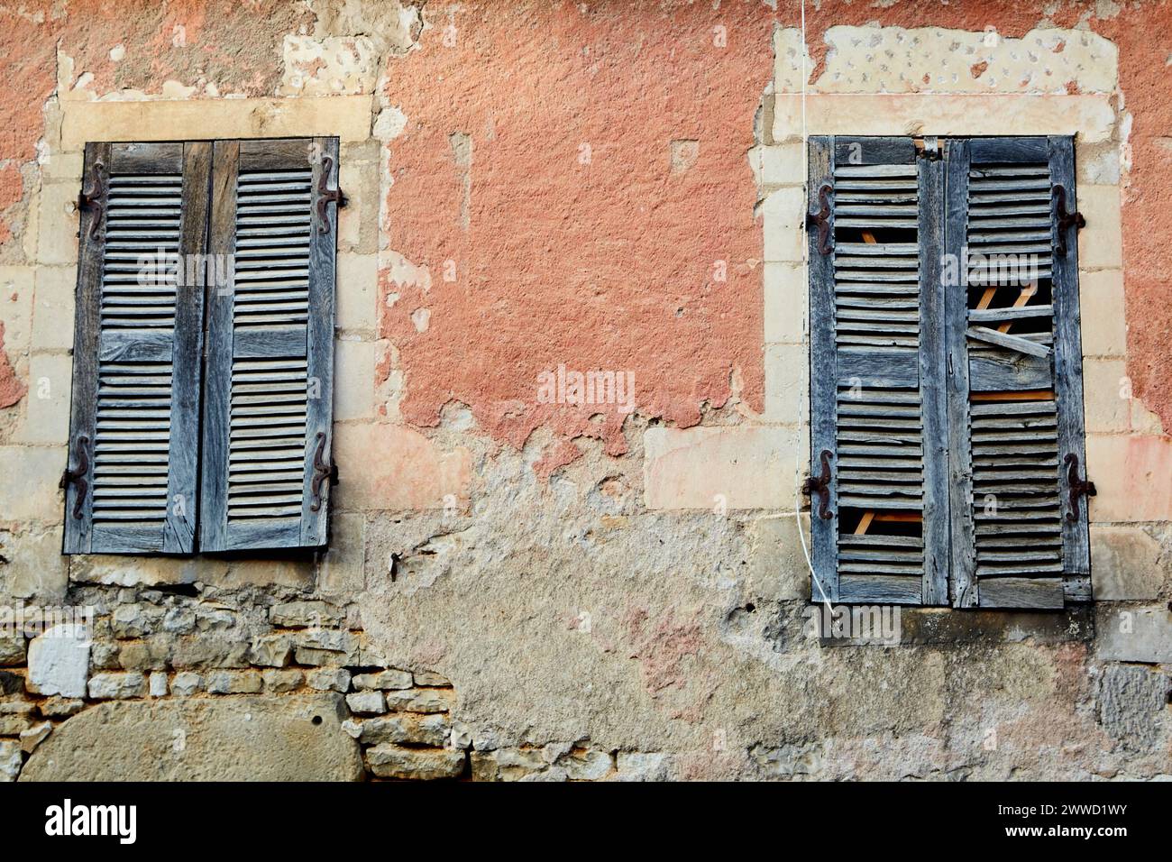 Broken Blue Shutters in an Orange Building Stock Photo - Alamy