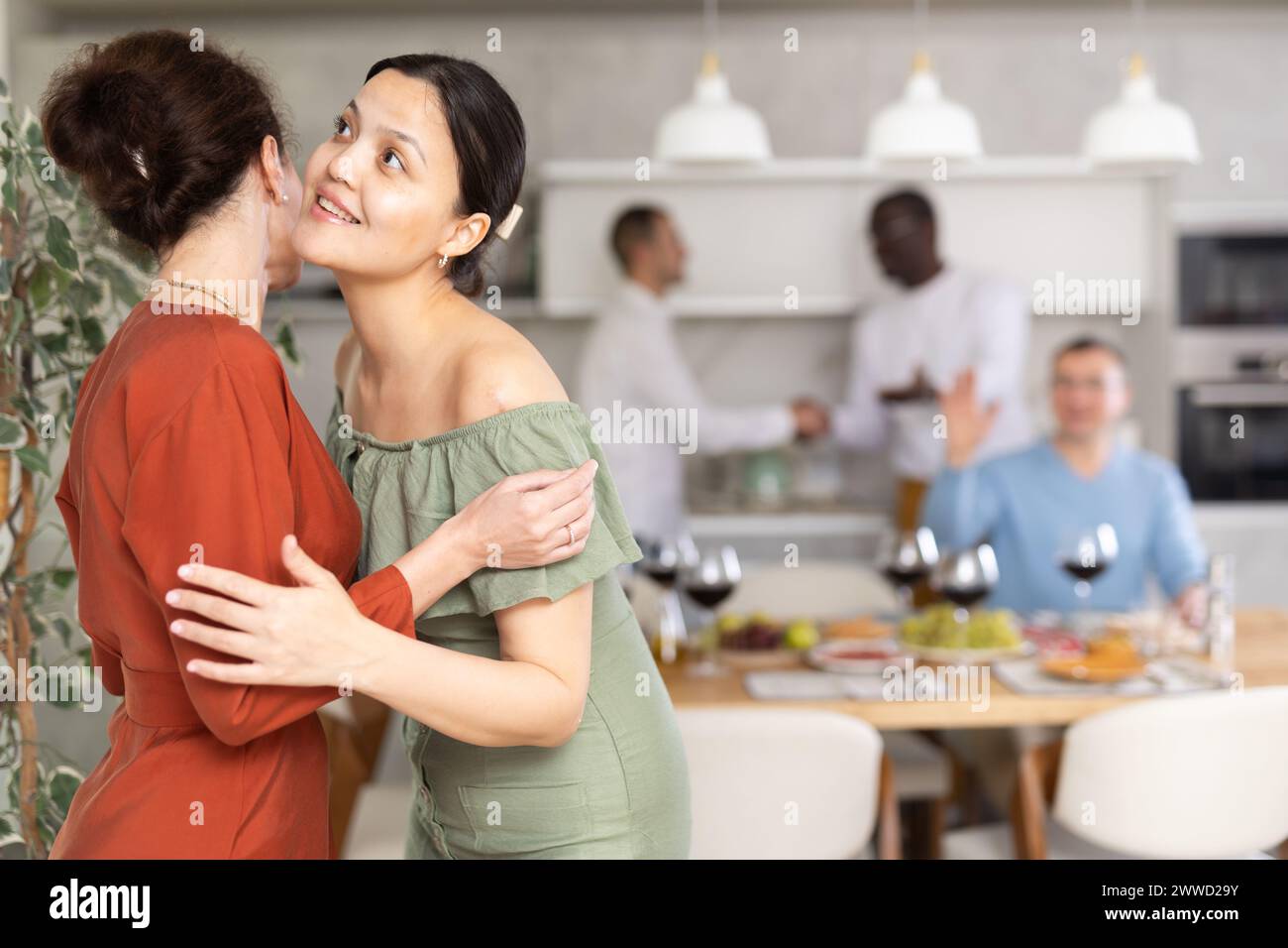 Two women greet each other when meeting Stock Photo - Alamy