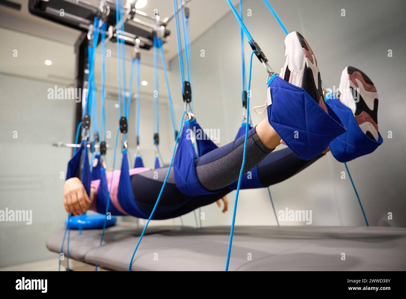 Woman hanging on suspension medical ropes after injury in ...