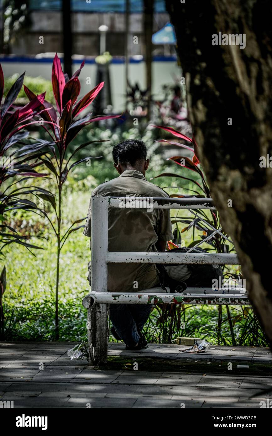 Makassar, South Sulawesi, Indonesia. 23rd Mar, 2024. A homeless man is ...