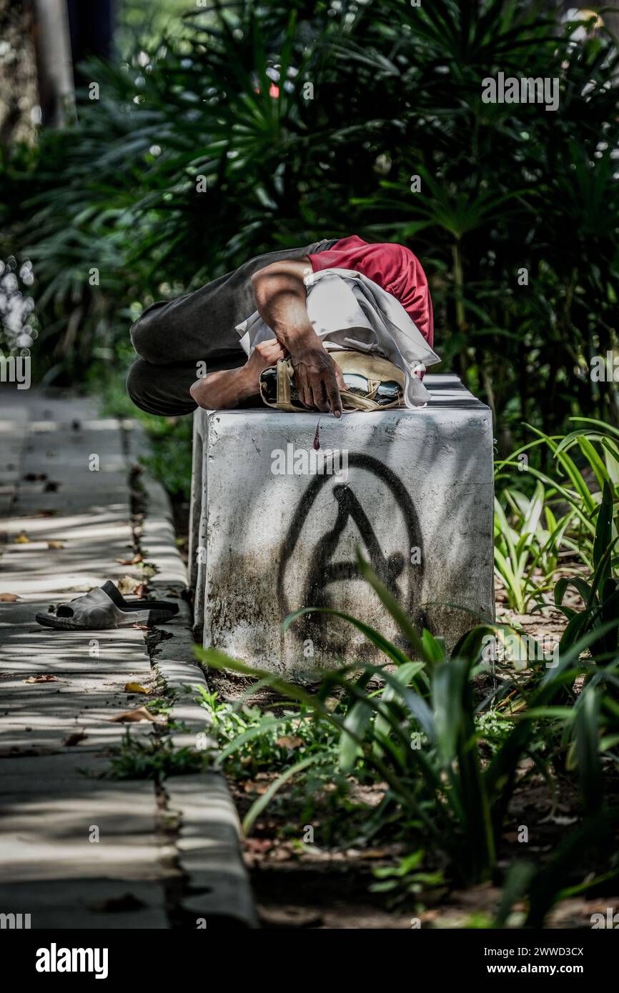 Makassar, South Sulawesi, Indonesia. 23rd Mar, 2024. A homeless man was ...