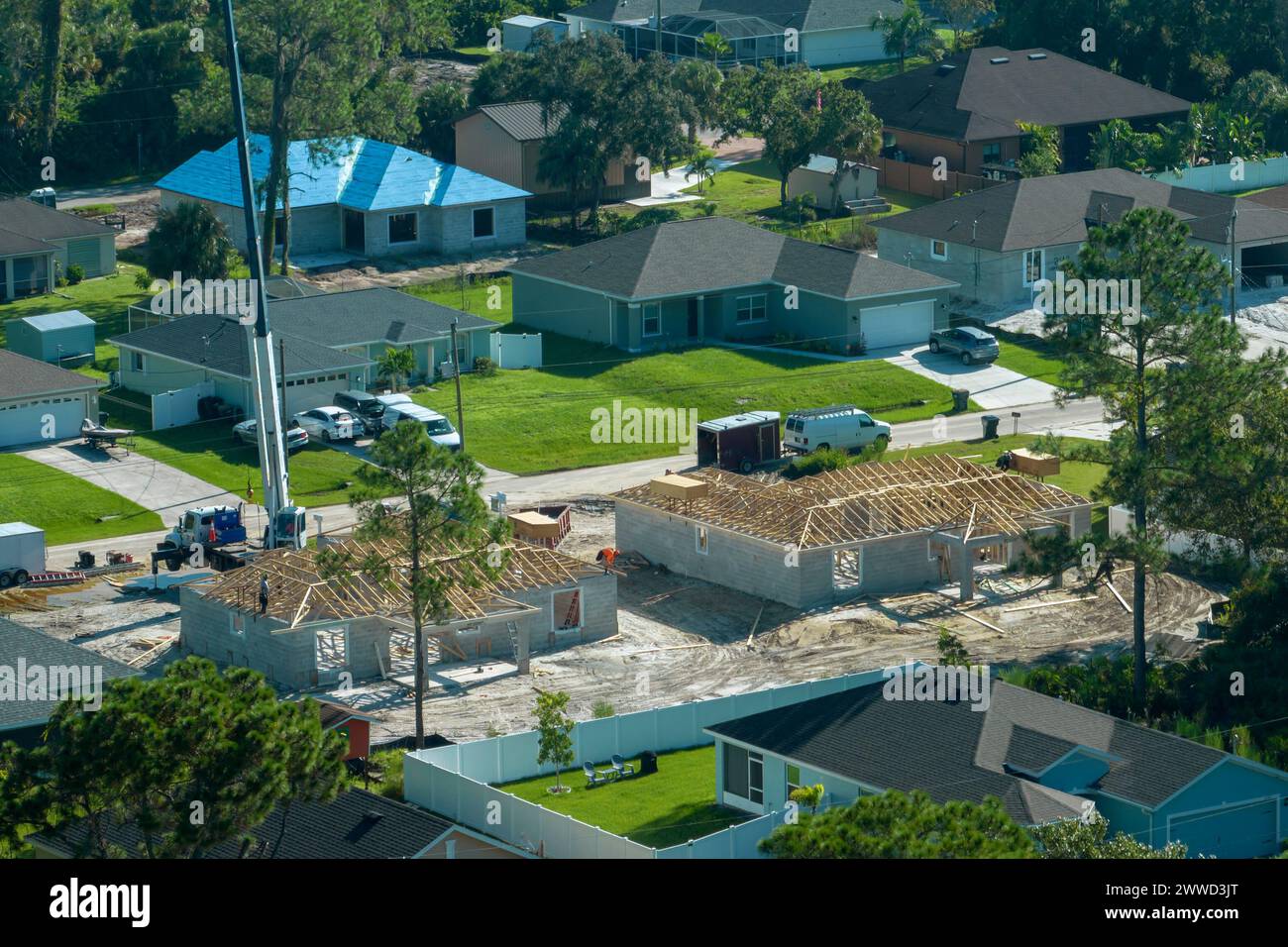 Aerial view of lifting crane and builders working on unfinished ...