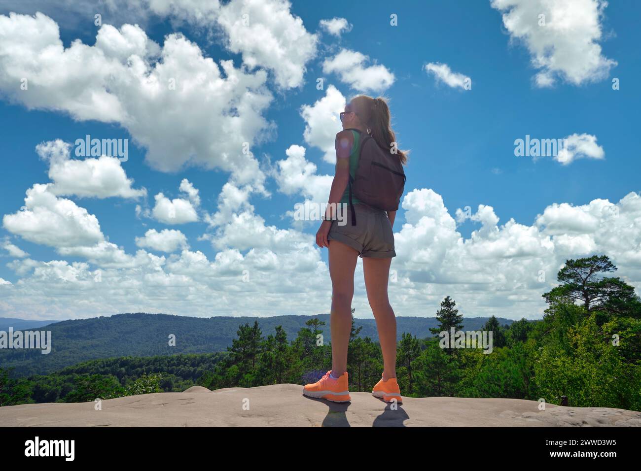 Hiker woman standing on mountain footpath enjoying nature during her ...