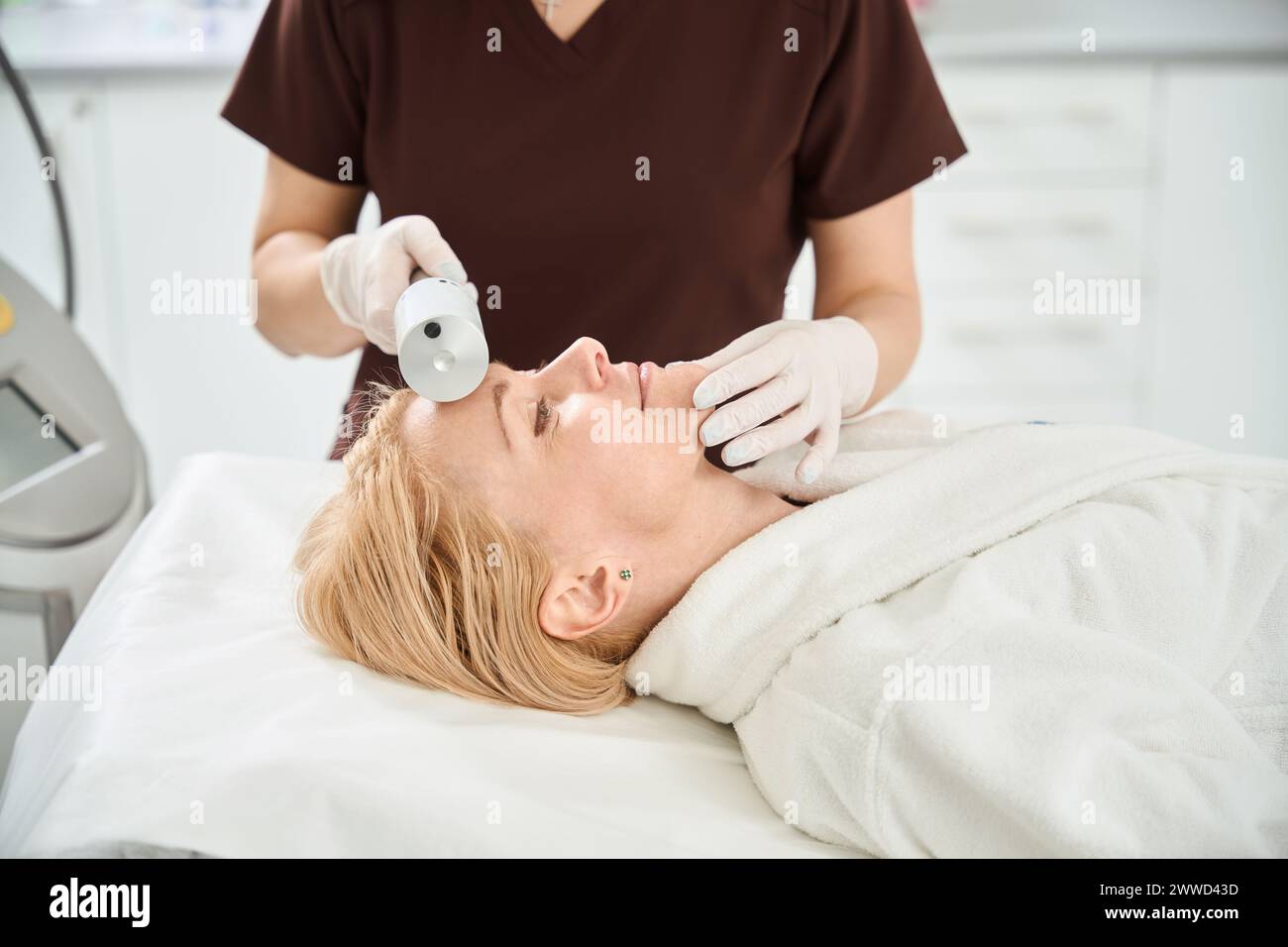 Cosmetologist rejuvenating skin on woman face with endosphere therapy ...