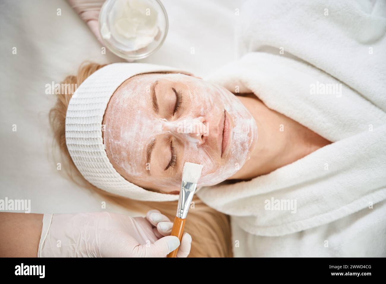Cosmetologist applying face alginate moisturizing hi-res stock ...