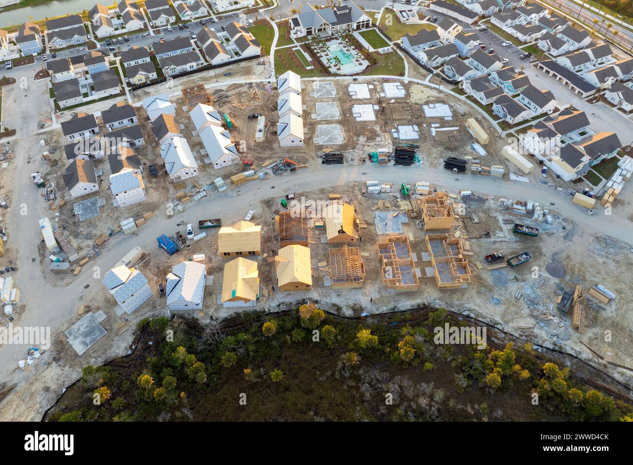 Unfinished frames of inexpensive homes with wooden roof beams under ...