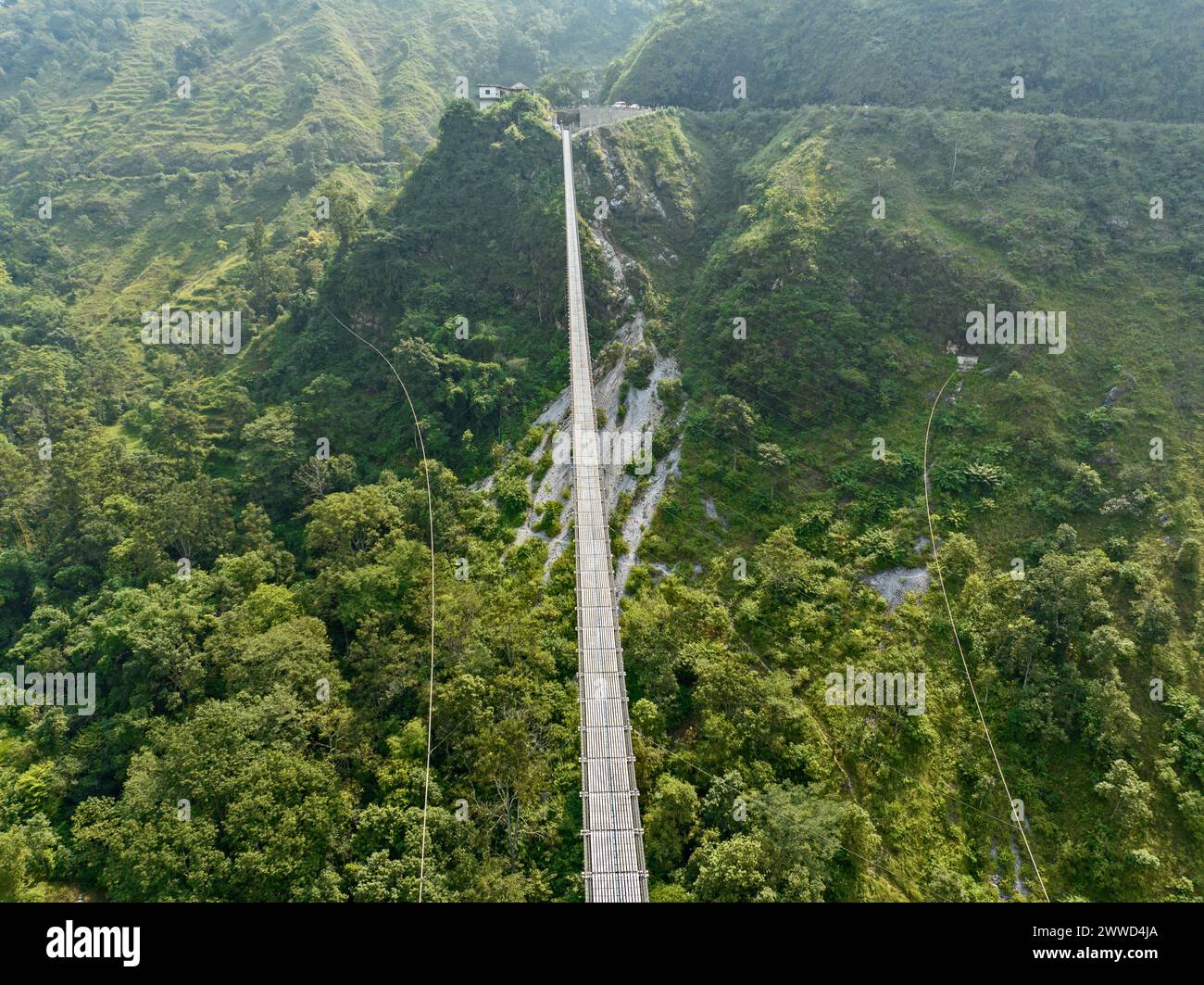 Aerial view of a Tibetan suspended bridge in Nepal is a primitive type ...